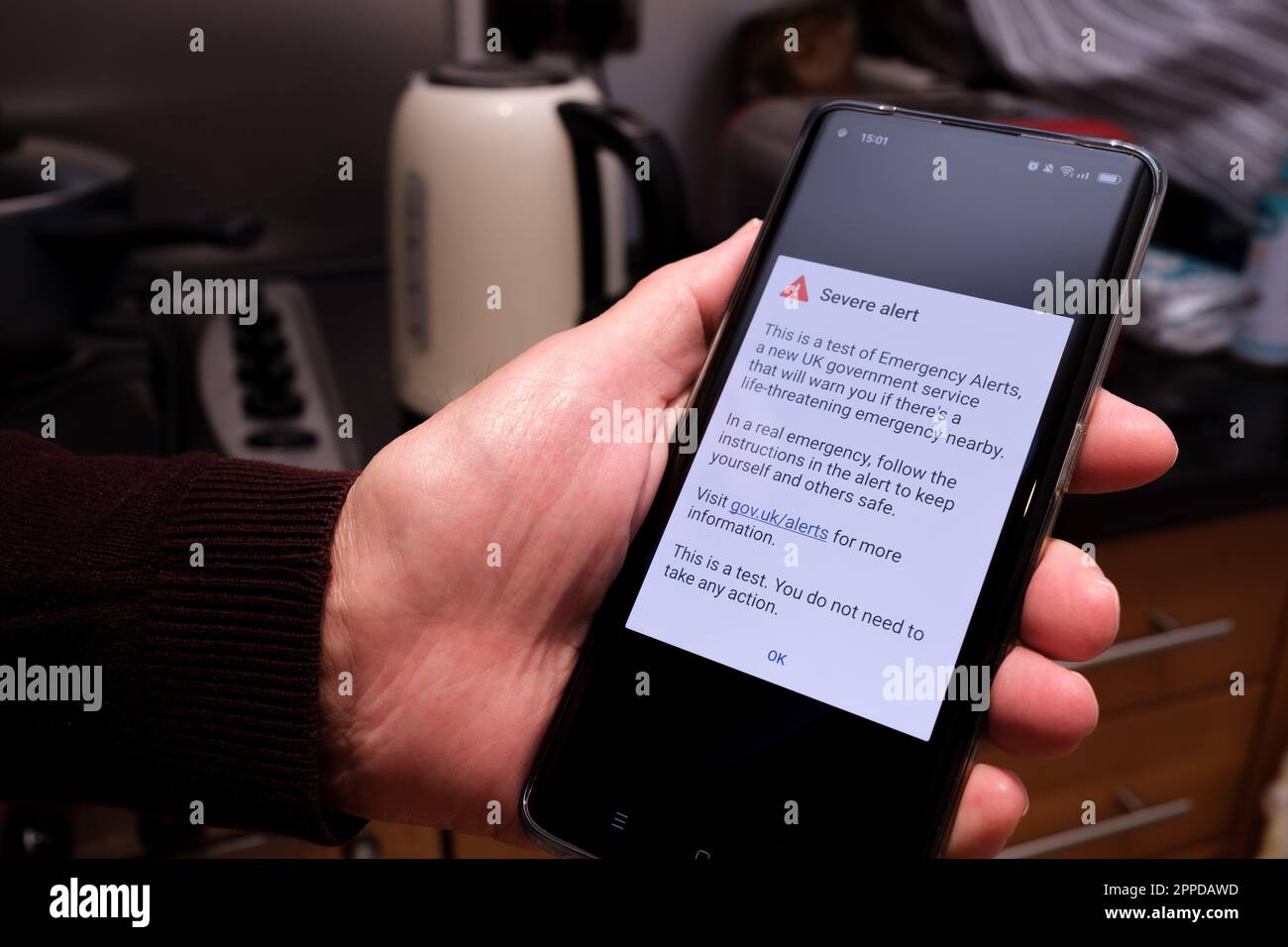 Severe Alert seen on the screen of smartphone hold in hand of elderly ...