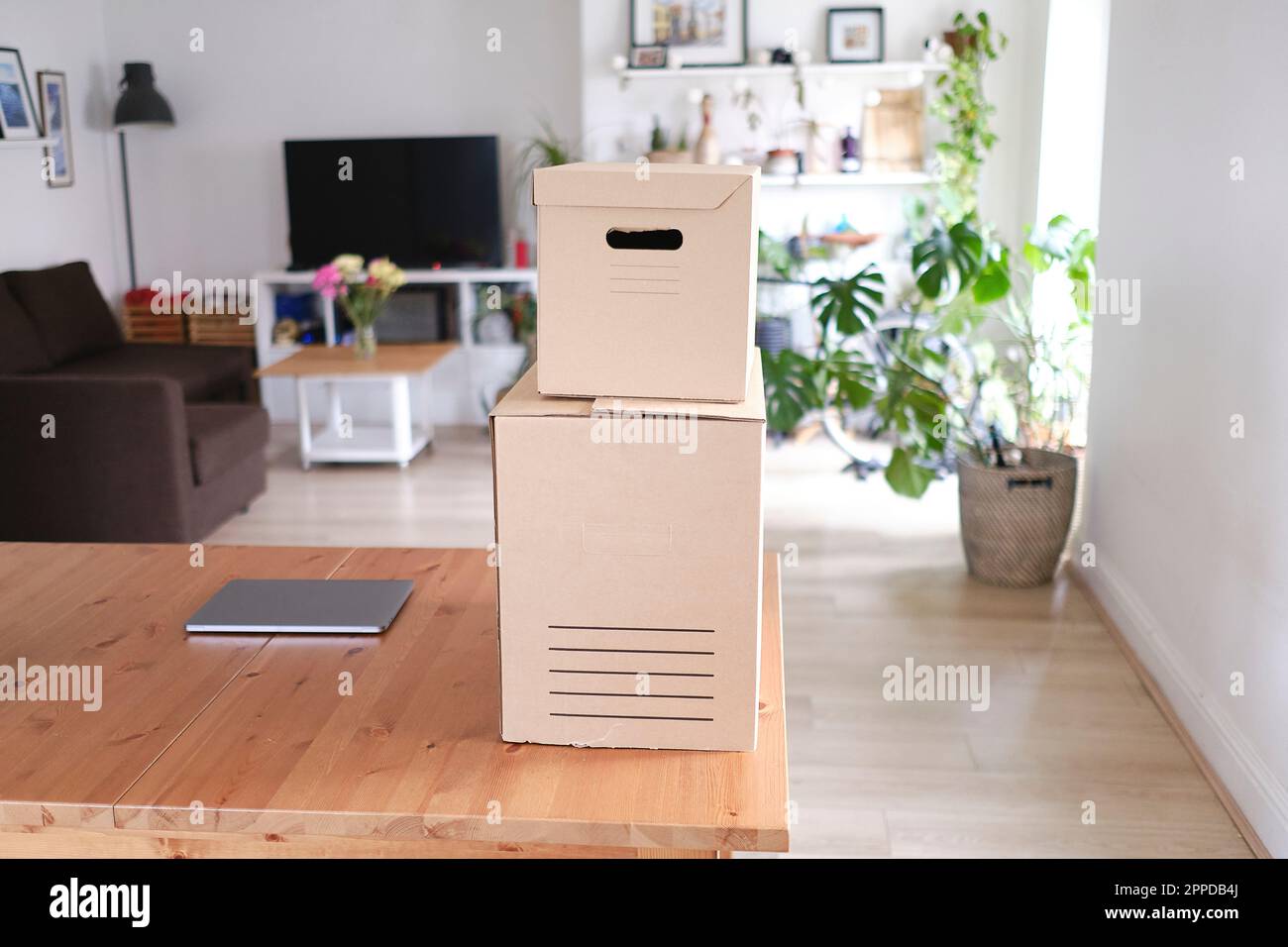 Cardboard boxes with laptop on desk at home Stock Photo - Alamy