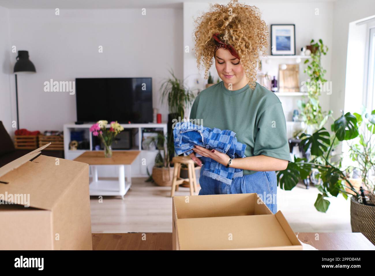 Young woman packing order in box Stock Photo - Alamy