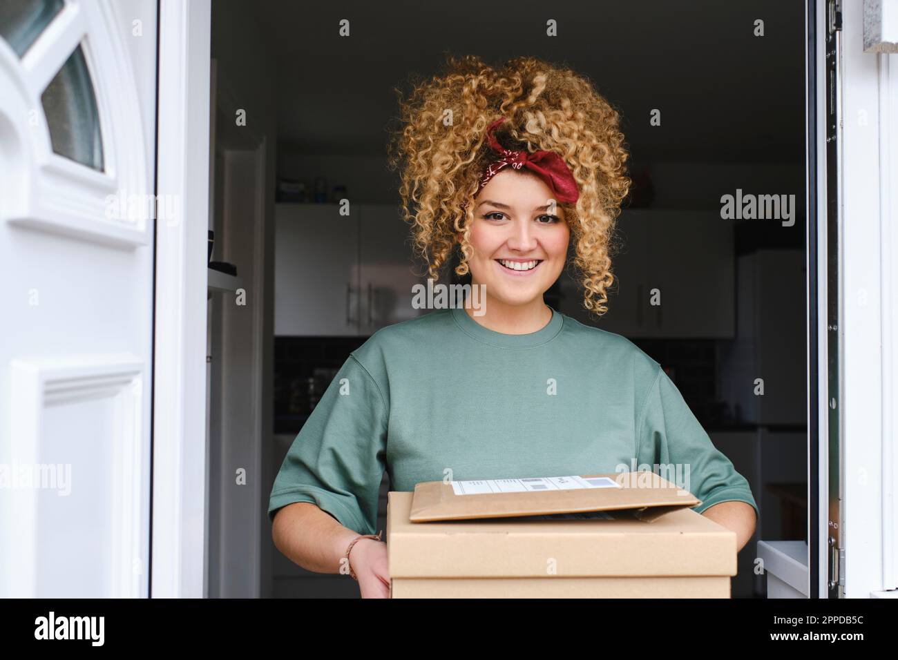 Woman packages doorstep hi-res stock photography and images - Alamy