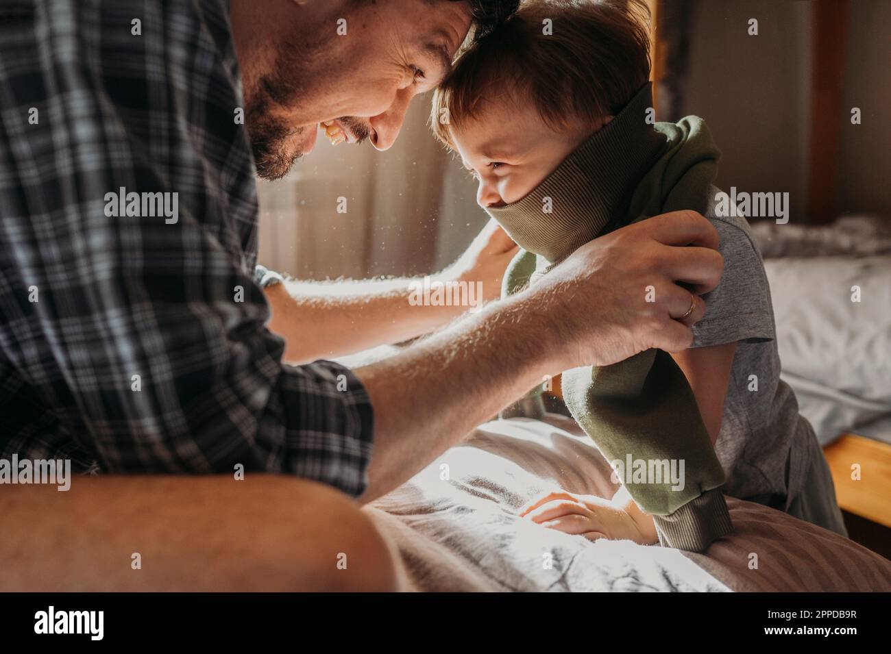 Happy father dressing up son at home Stock Photo - Alamy
