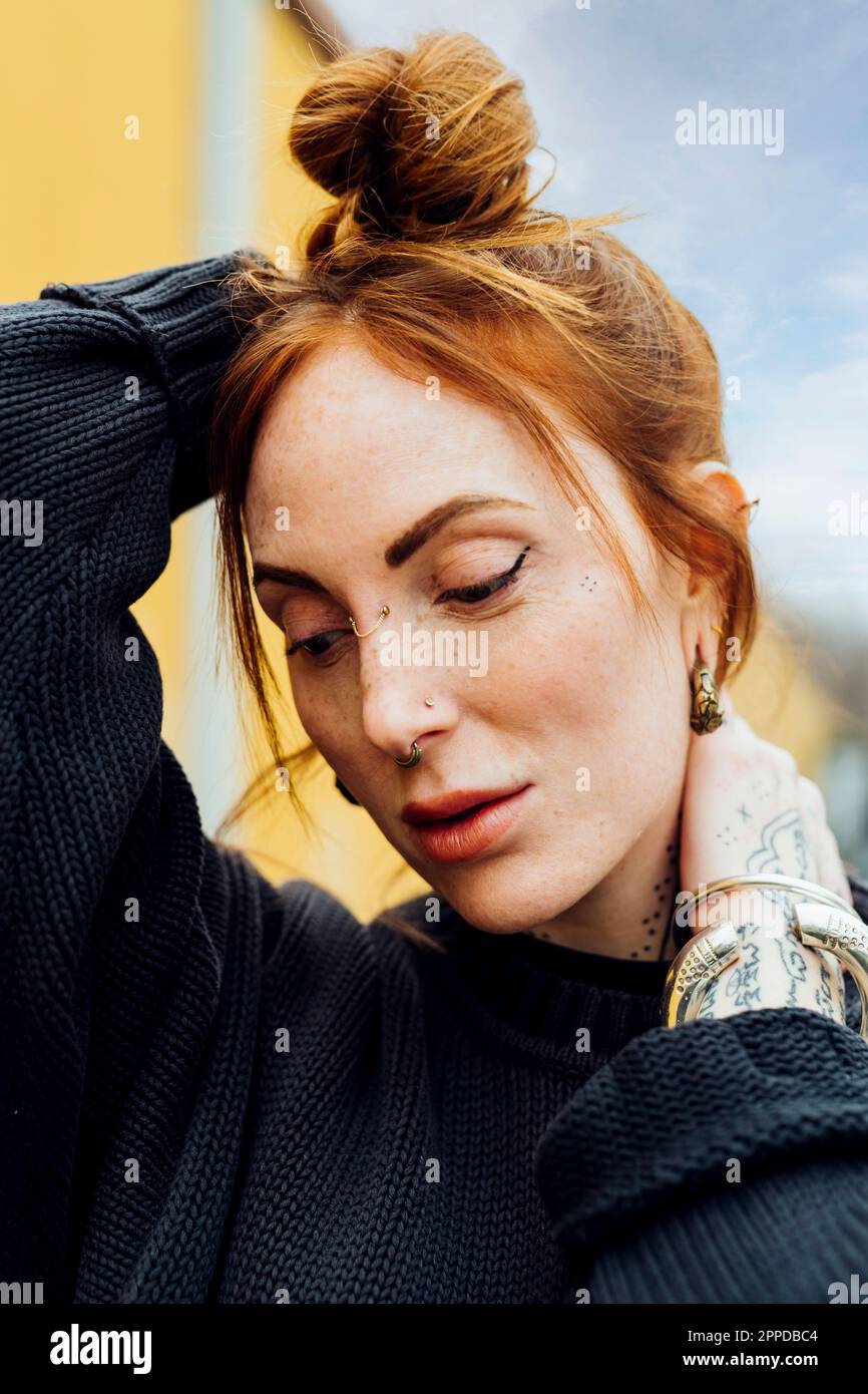 Redhead woman with topknot hair bun Stock Photo - Alamy