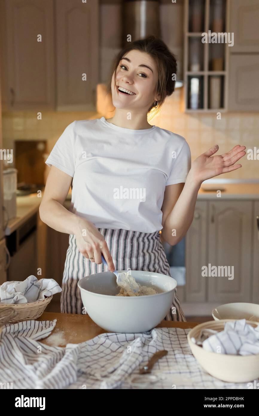 Happy young woman pointing at bread dough in bowl Stock Photo - Alamy