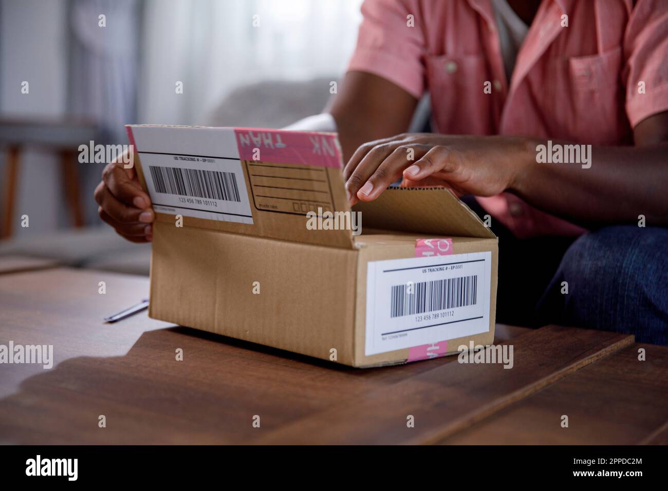 Man unboxing cardboard container at home Stock Photo - Alamy