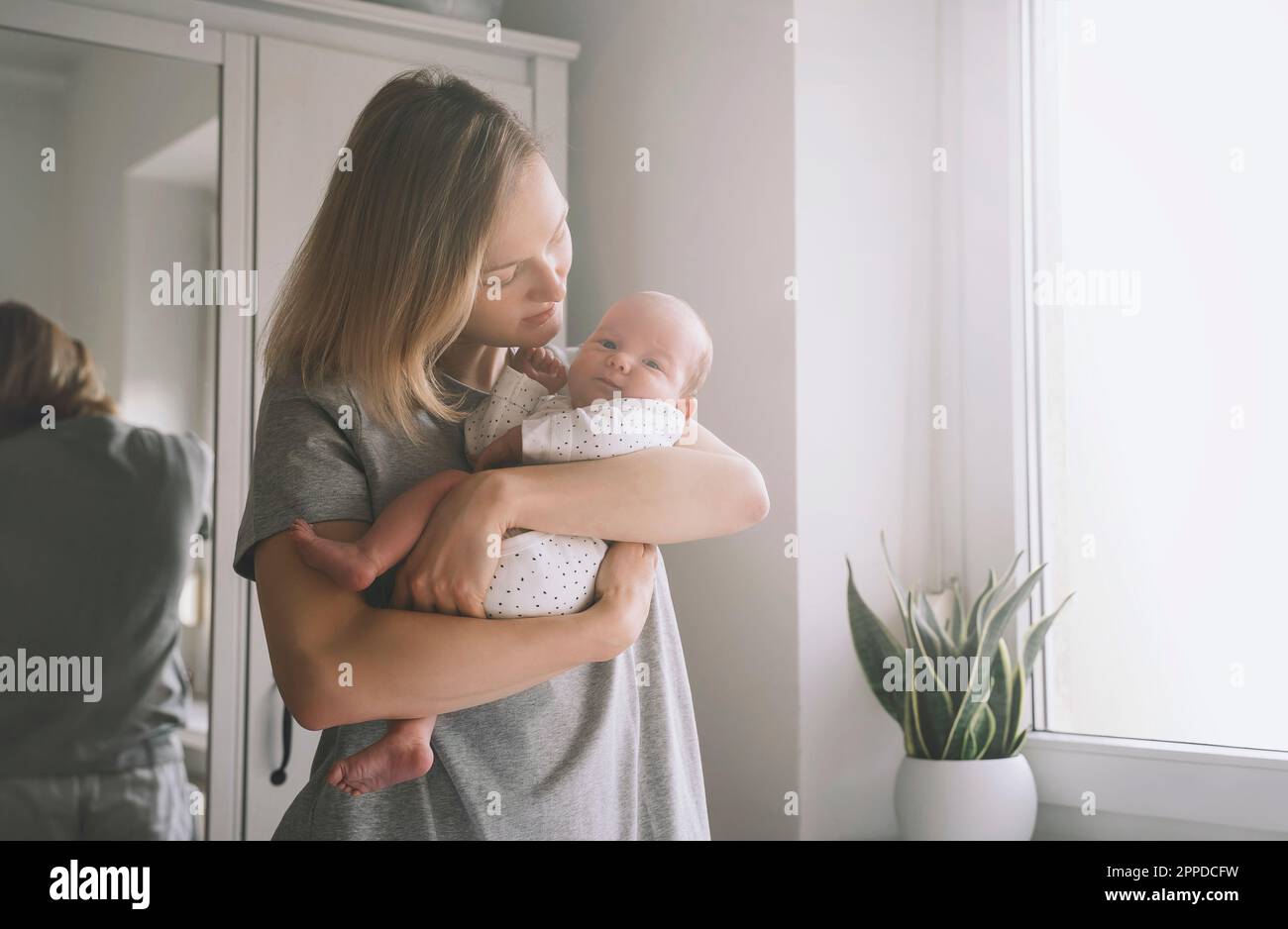 Mother comforting her baby boy at home Stock Photo - Alamy
