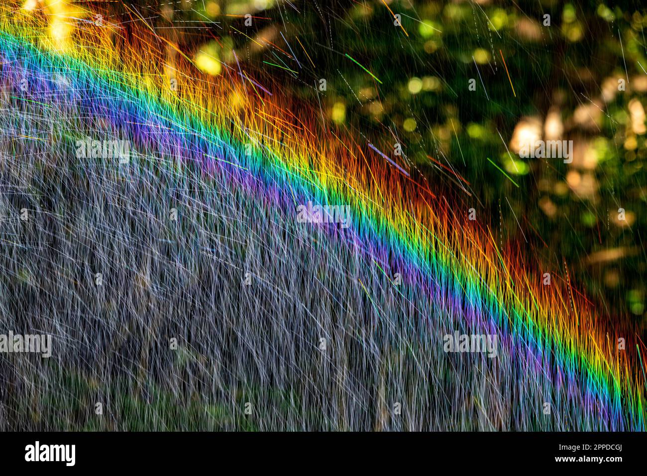 Long exposure of spray of water covered in rainbow colored light Stock ...
