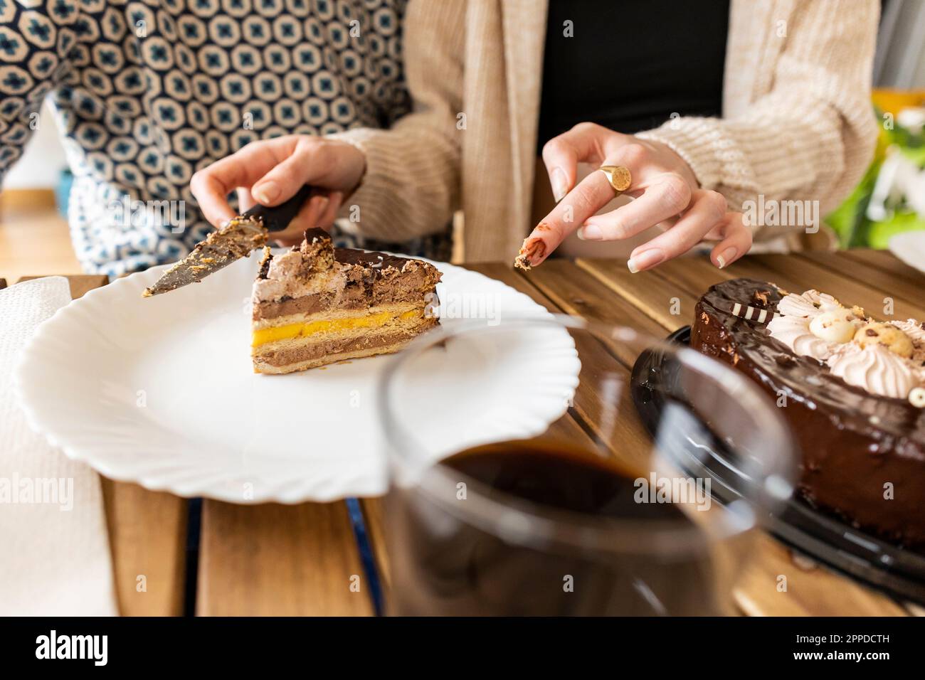 Young woman serving cake to mother at home Stock Photo - Alamy