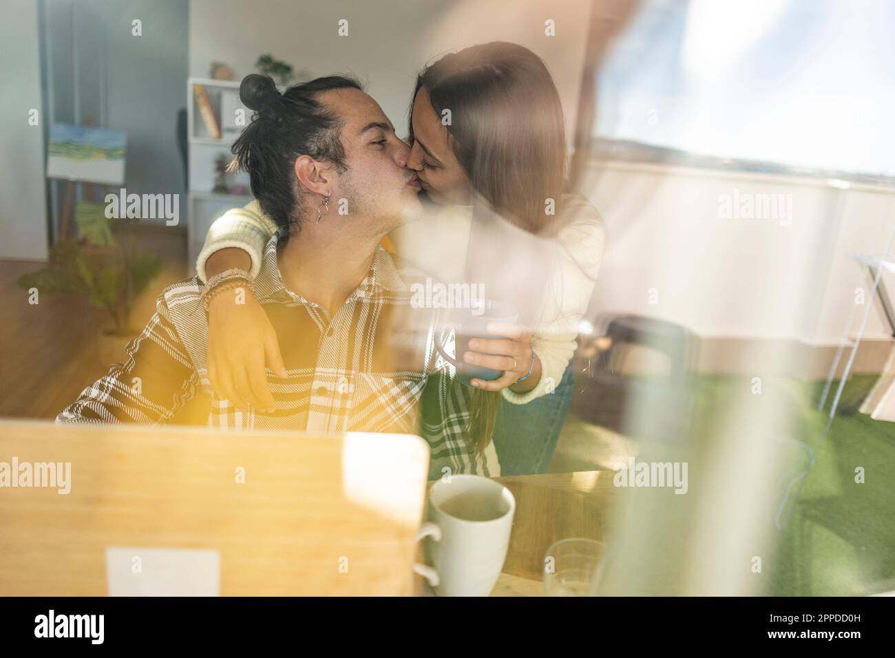 Romantic couple kissing on mouth seen through glass Stock Photo - Alamy