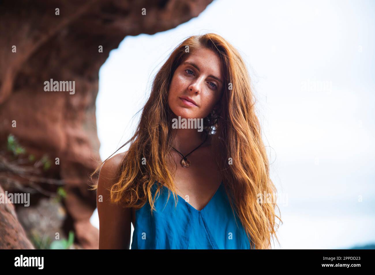 Young woman standing in front rock hi-res stock photography and images ...