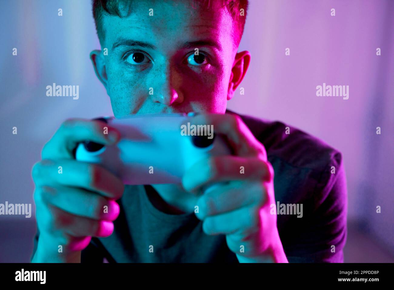 Thoughtful young man playing video game Stock Photo - Alamy