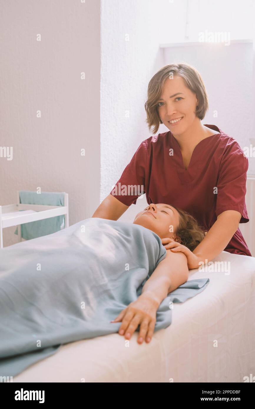 Happy therapist giving body massage to customer Stock Photo - Alamy