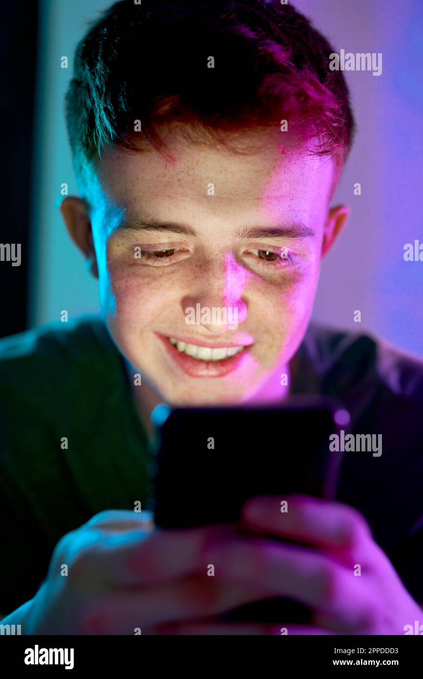 Happy young man surfing net using smart phone Stock Photo - Alamy