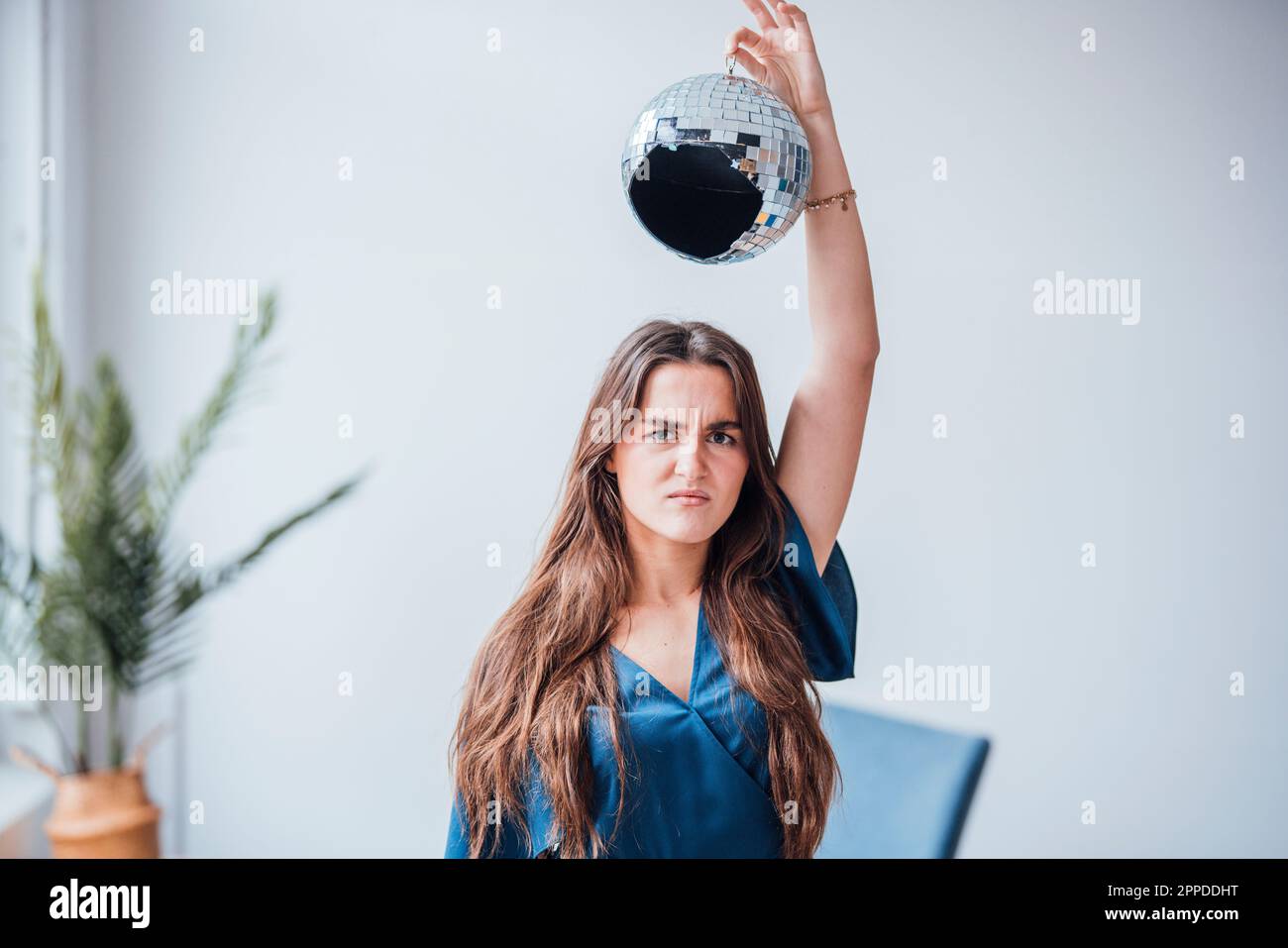 Angry businesswoman holding broken disco ball over head Stock Photo - Alamy