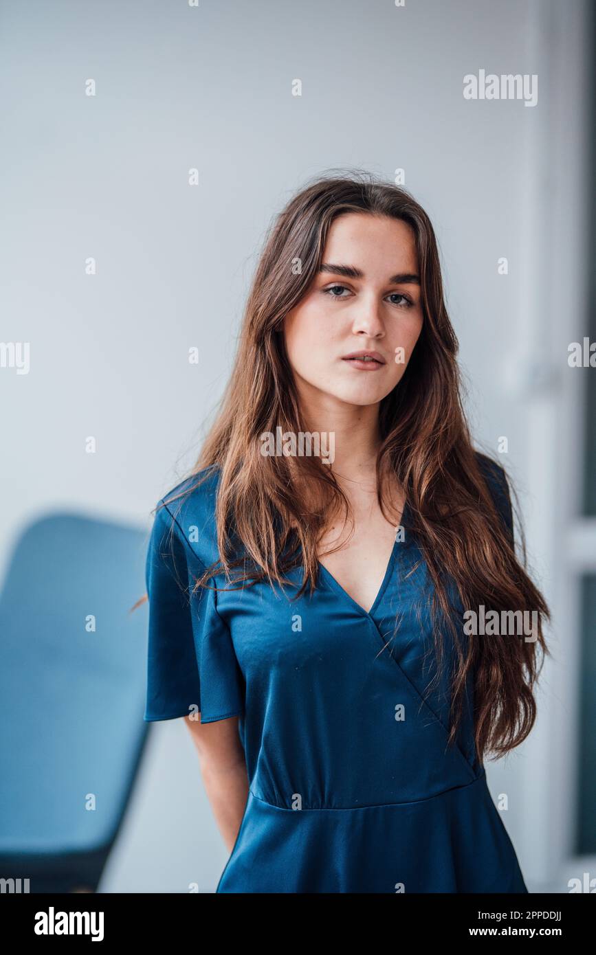 Confident businesswoman with hands behind back standing in office Stock ...