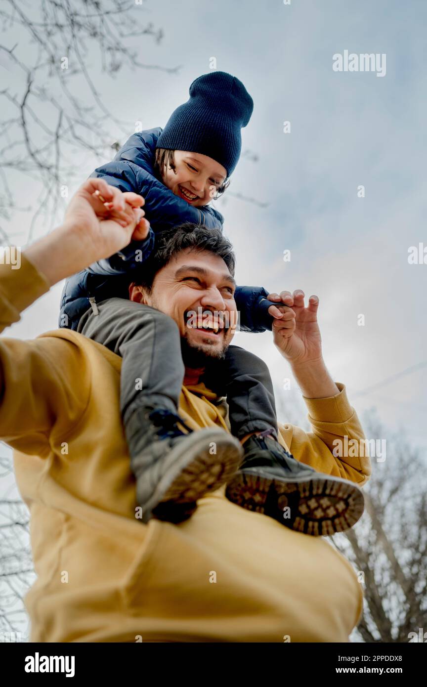 Father playing with son sitting on shoulder Stock Photo - Alamy