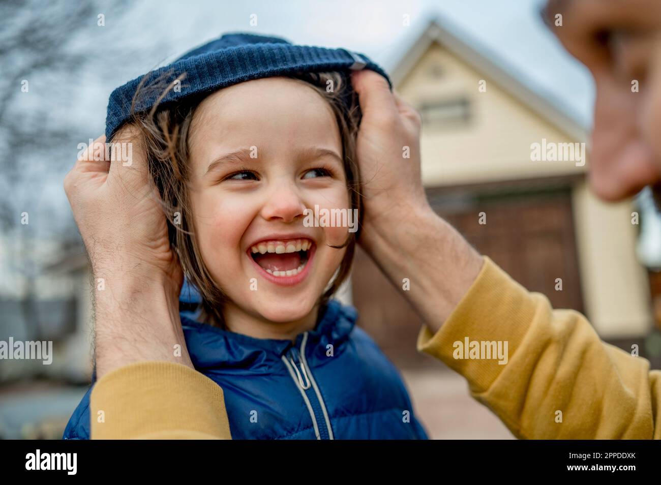 Boy putting on hat head hi-res stock photography and images - Alamy