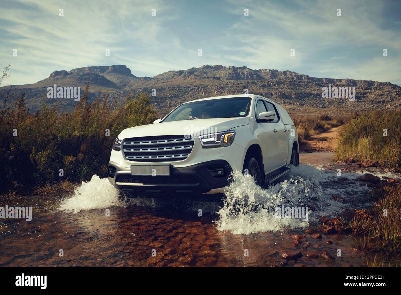 Off road vehicle splashing water in stream Stock Photo - Alamy