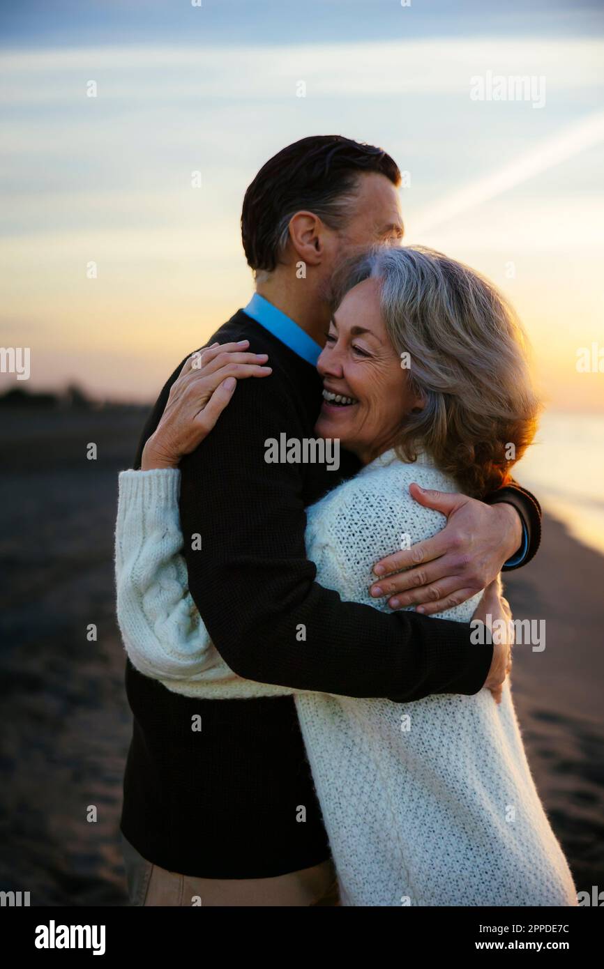 Mature couple hugging each other at beach Stock Photo - Alamy