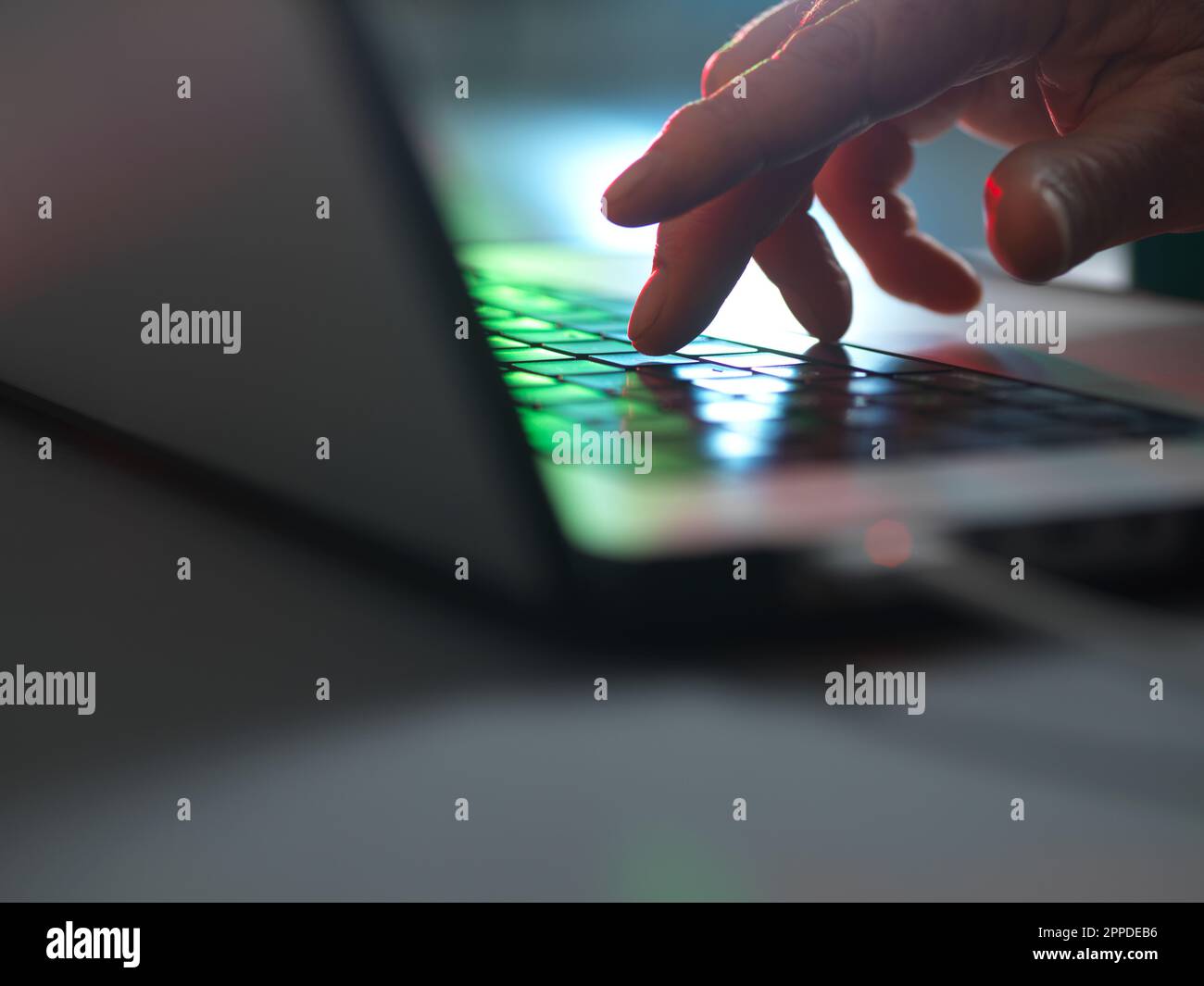 Hands touching laptop keyboard in dark at home office Stock Photo - Alamy