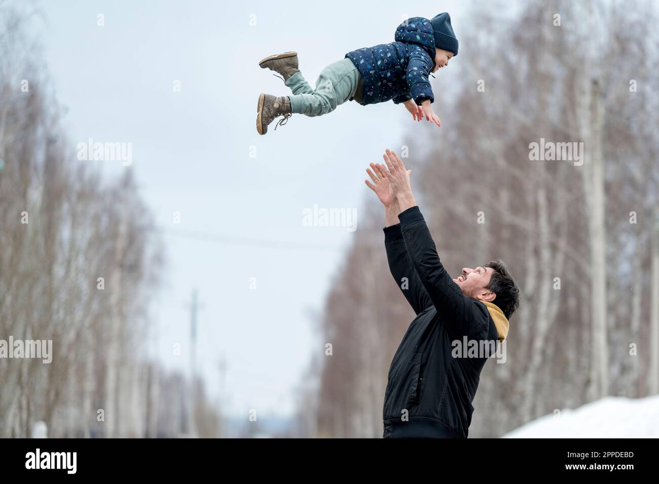 Playful father throwing son in air Stock Photo - Alamy