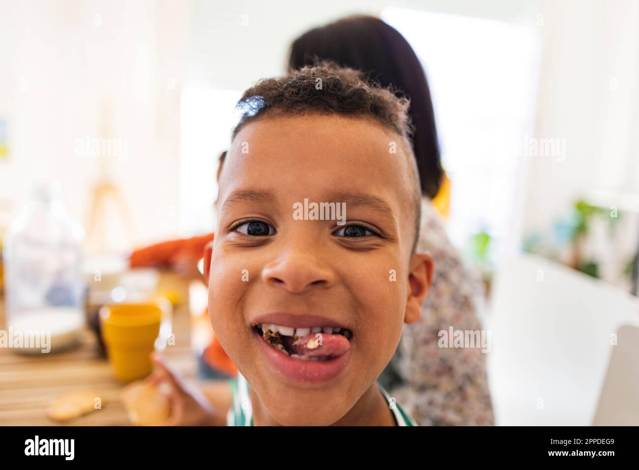 Happy boy eating breakfast at home Stock Photo - Alamy
