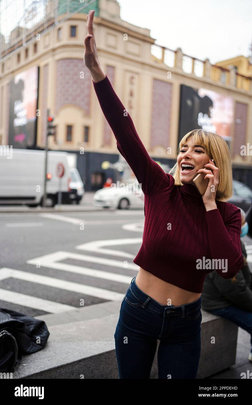 Excited woman greeting waving hand hi-res stock photography and images ...