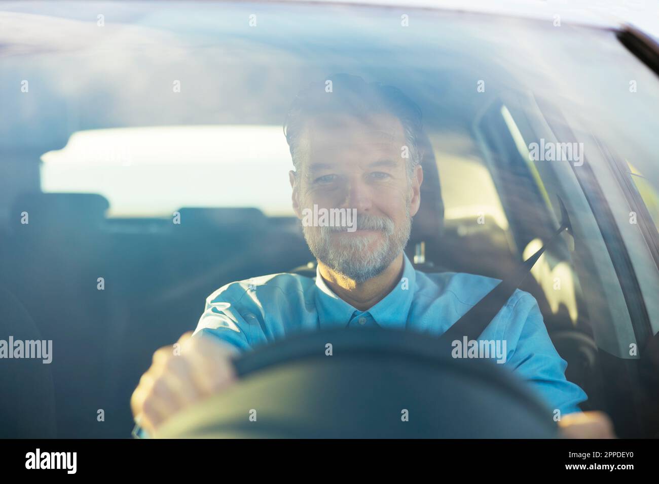 Man driving car seen through windshield Stock Photo - Alamy