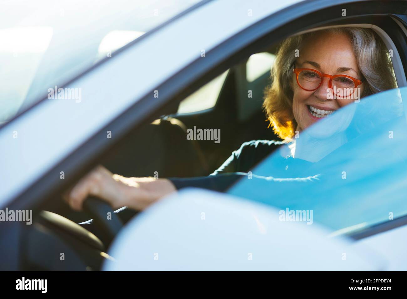 Happy mature woman driving car Stock Photo - Alamy