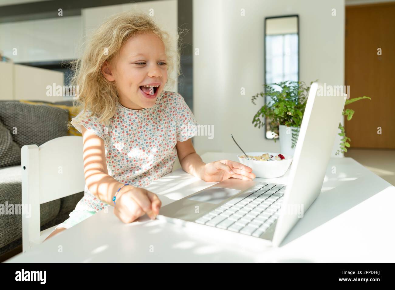 Happy blond girl laptop hi-res stock photography and images - Alamy