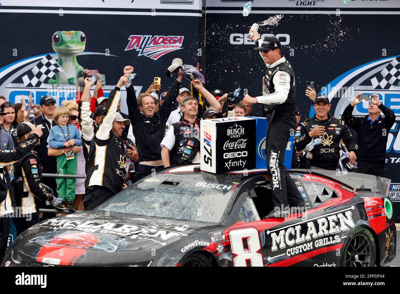 Kyle Busch, front right, celebrates in Victory Lane after winning a ...