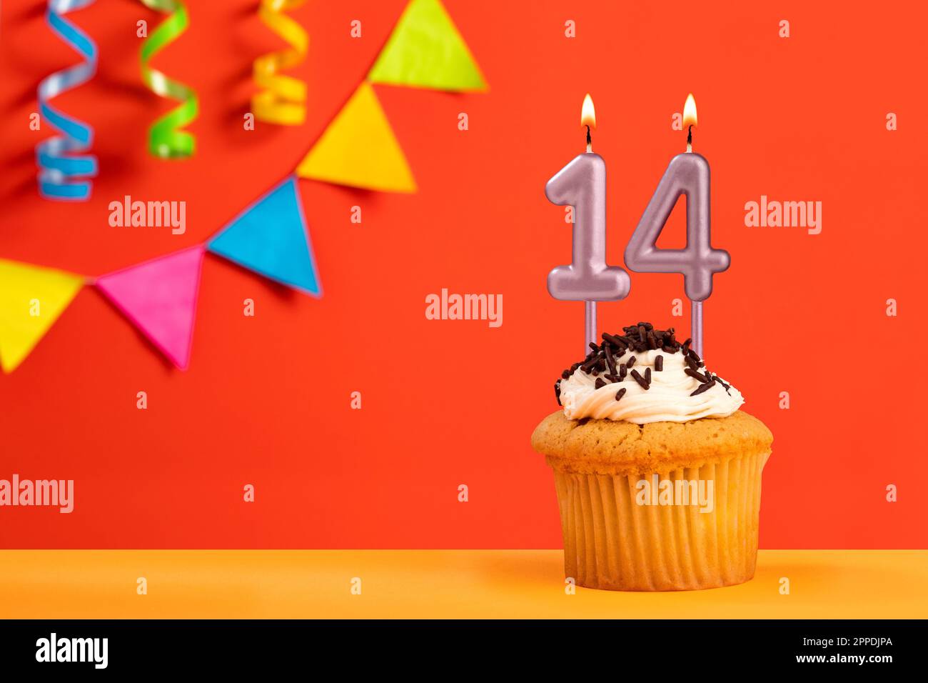 Birthday cake with number 14 candle - Sparkling orange background with ...