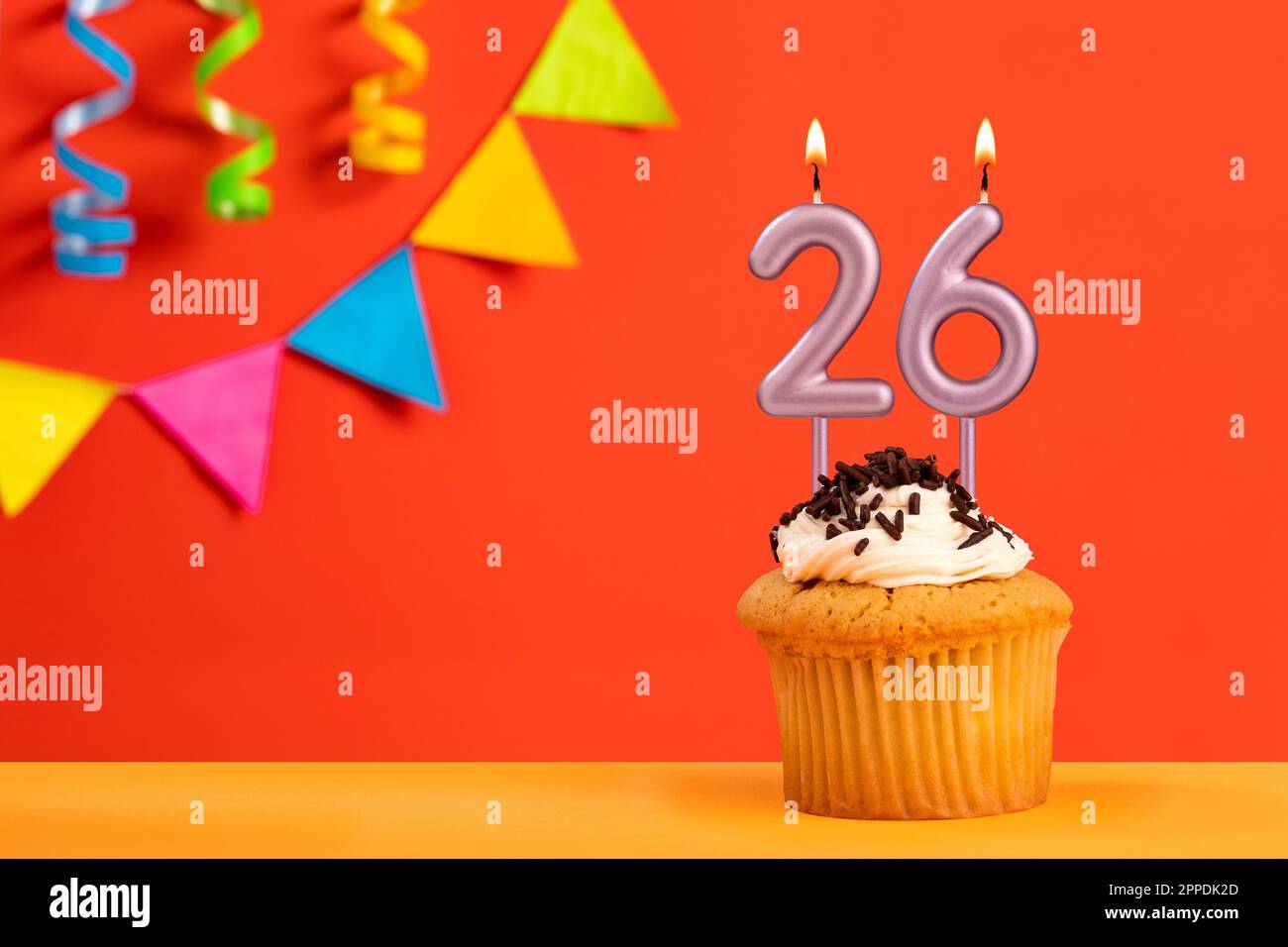 Birthday cake with number 26 candle - Sparkling orange background with ...