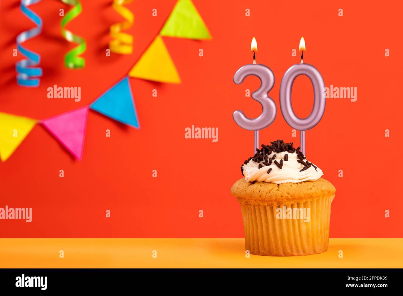 Birthday cake with number 30 candle - Sparkling orange background with ...