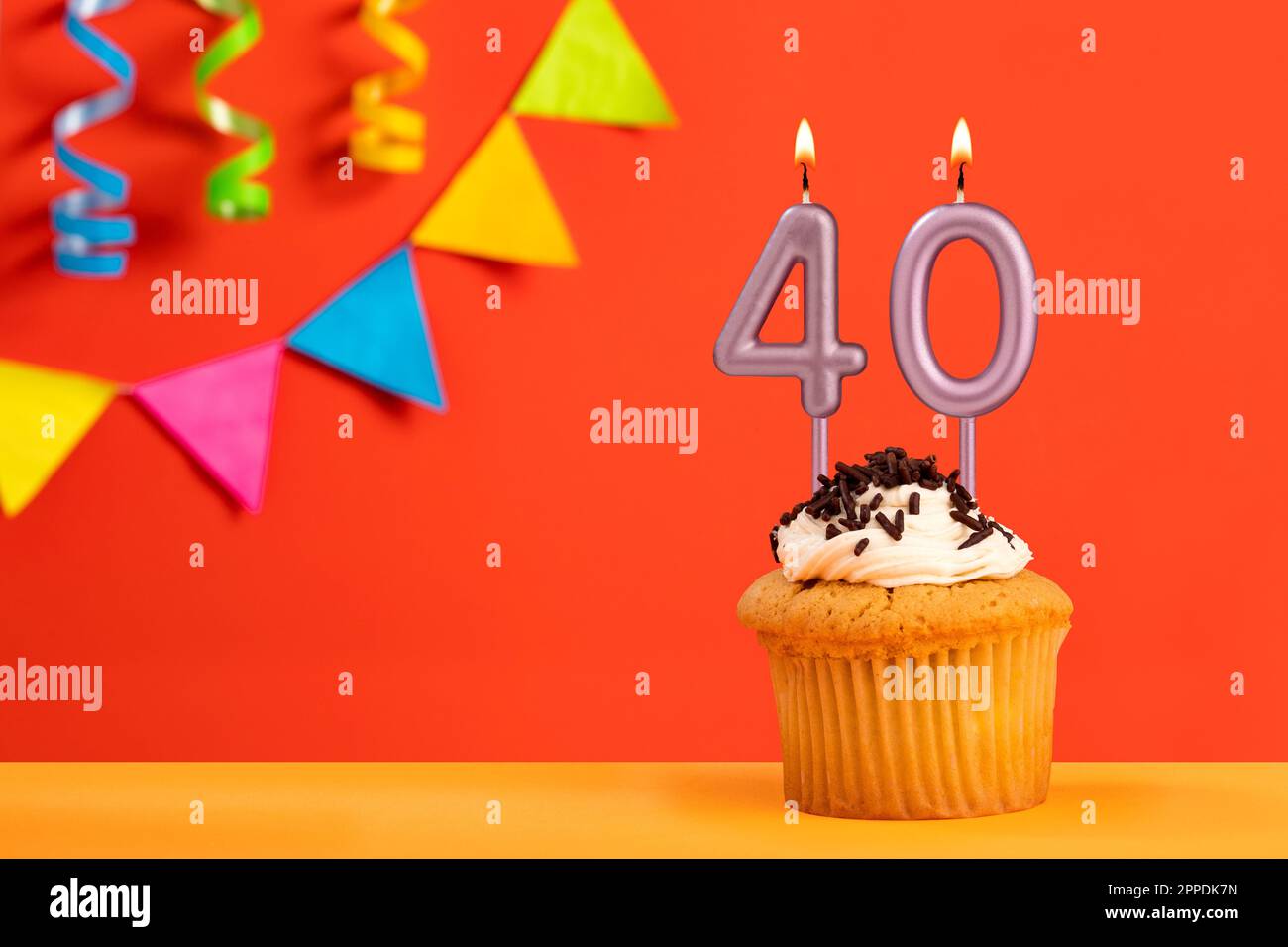 Birthday cake with number 40 candle - Sparkling orange background with ...