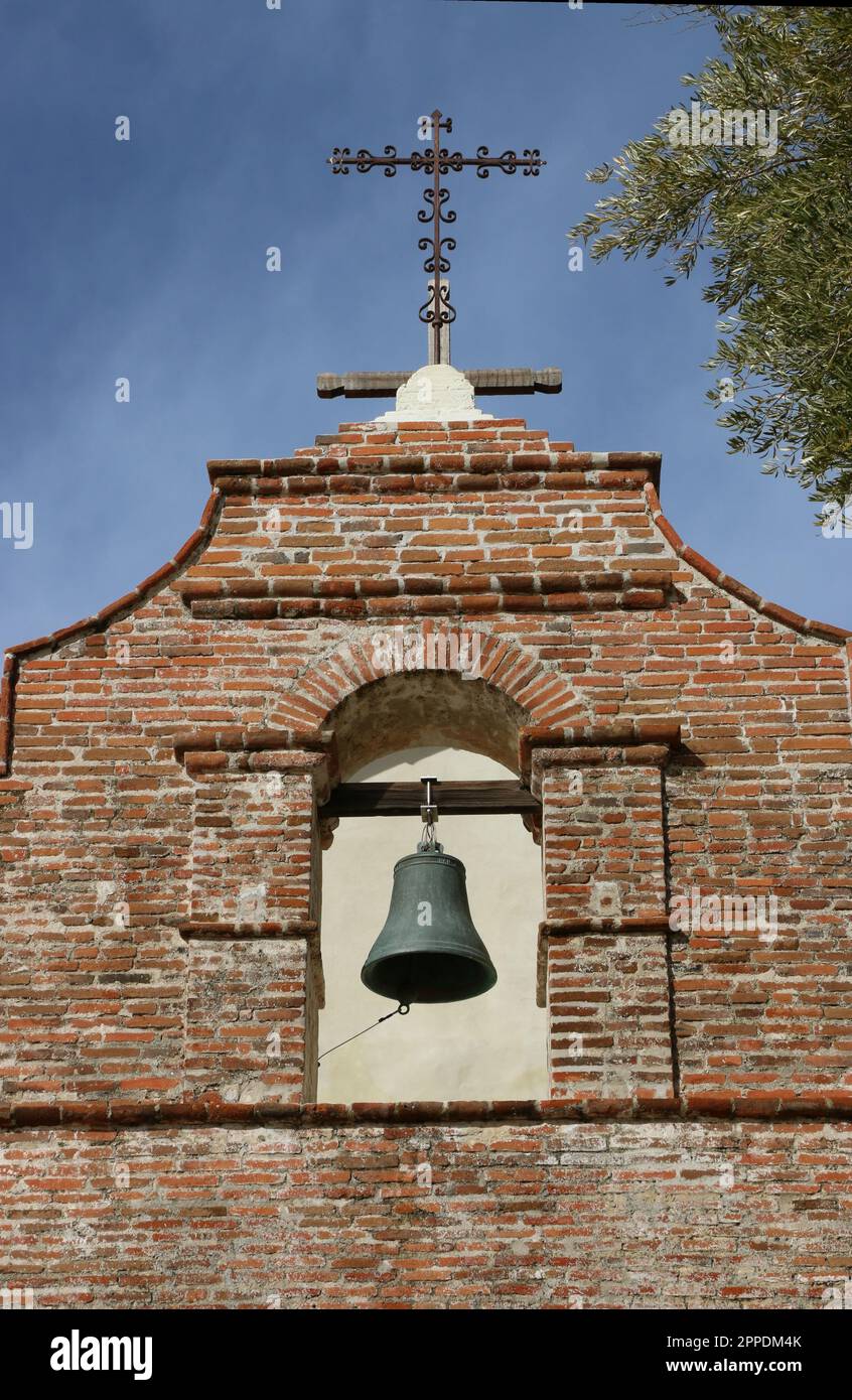 An old bell tower with a cross at the Mission San Antonio de Padua ...