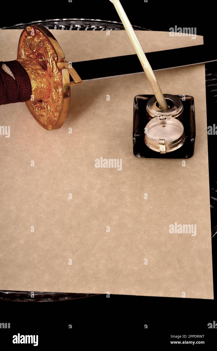 Quill parchment sword and ink well isolated over black Stock Photo - Alamy