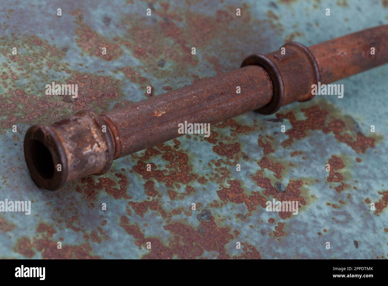 Rusty valve pipes on rusty metal wall background Stock Photo - Alamy