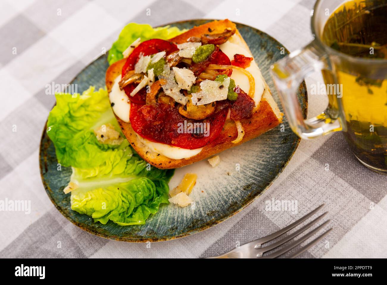 Hot tasty toasts with chorizo, tomatoes and cheese Stock Photo - Alamy