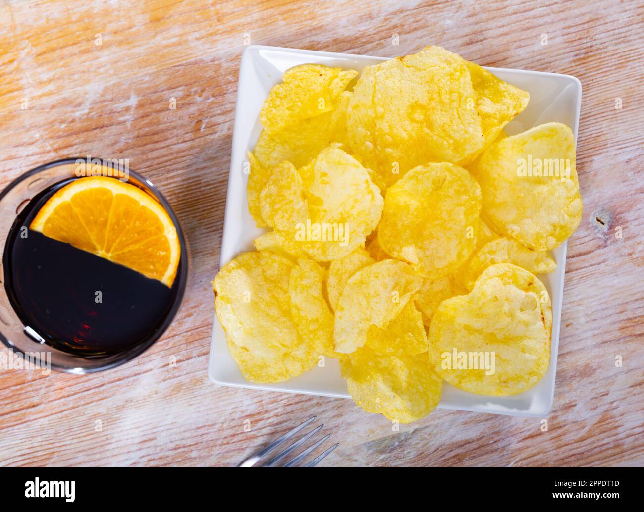 Round potato chips served in plate with a glass of vermouth Stock Photo ...