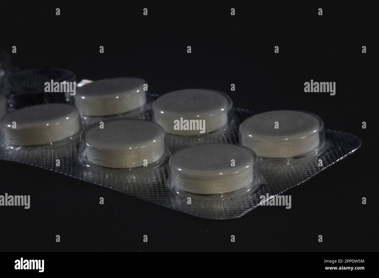 picture of a half empty blister pack of tablets, white pills, of pain ...