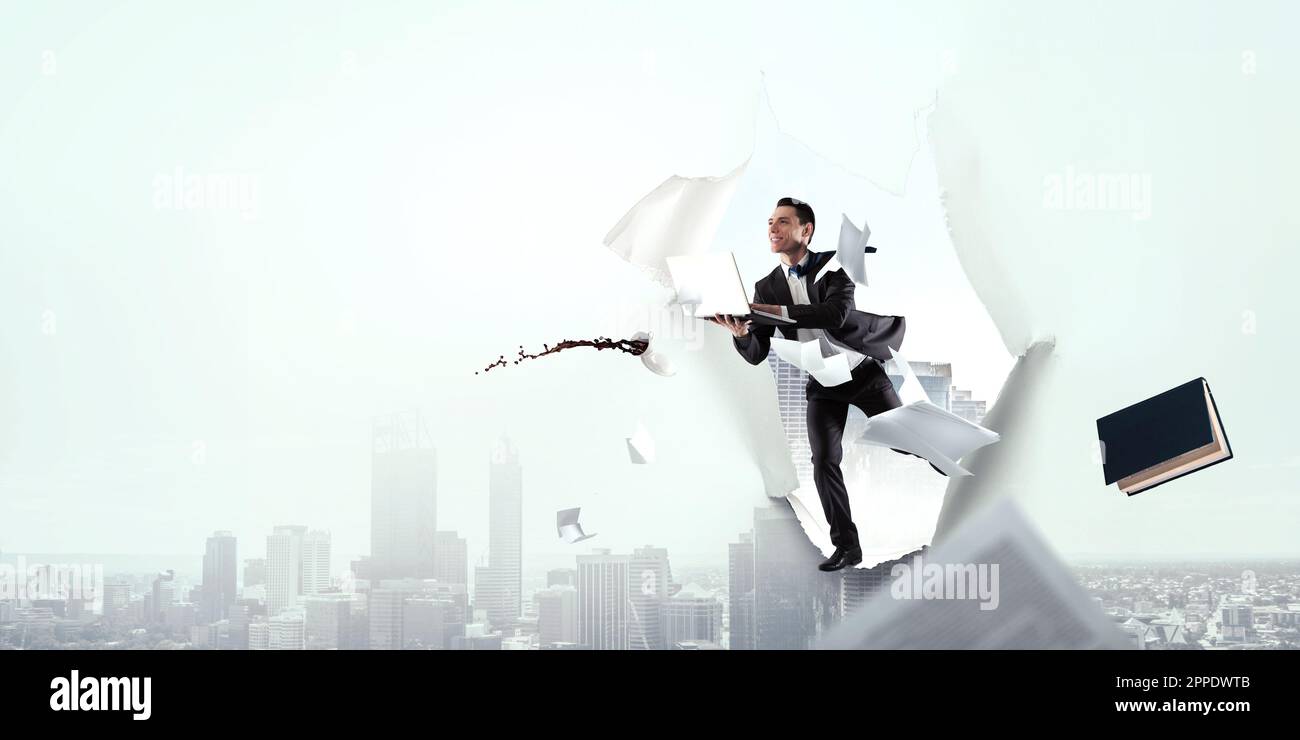 The business man is running with his notebook through paper hole Stock ...