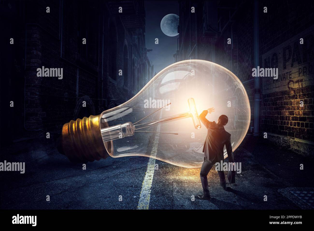 Huge light bulb glowing in the darkness Stock Photo - Alamy