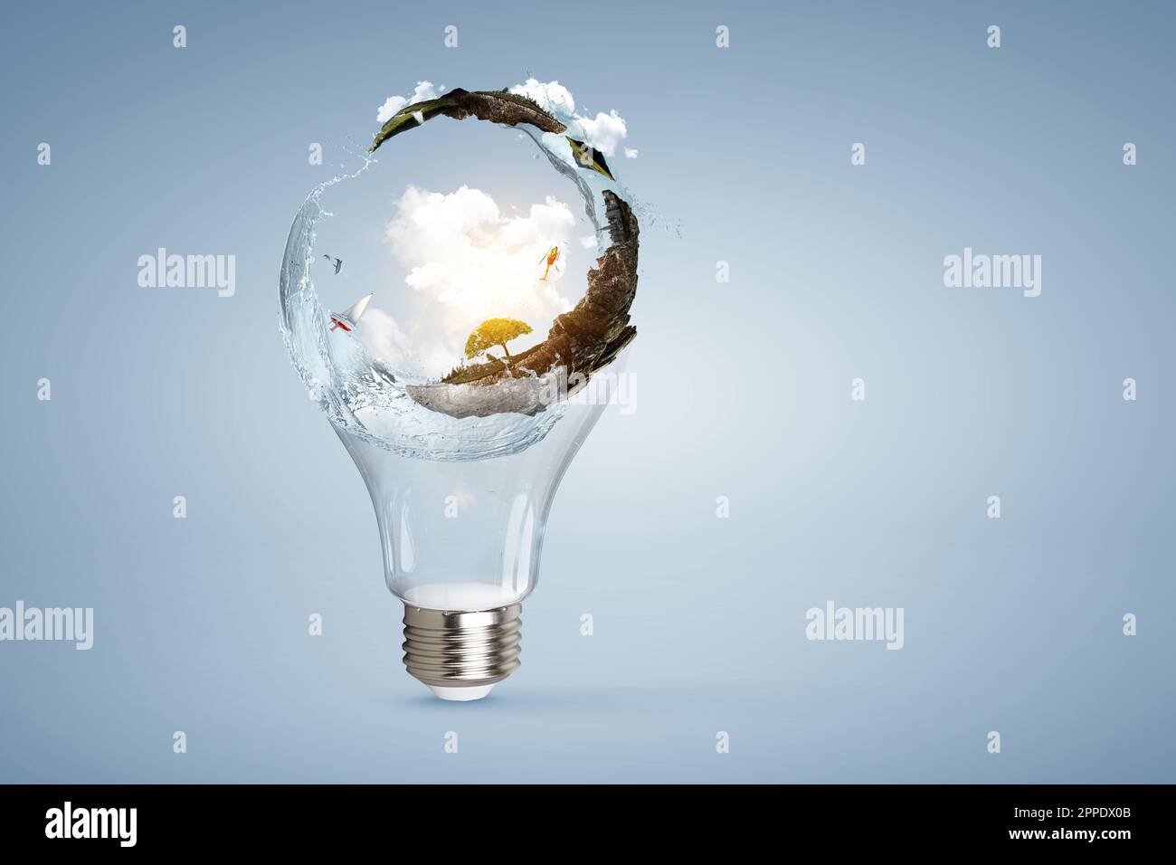 Green landscape inside light bulb Stock Photo - Alamy