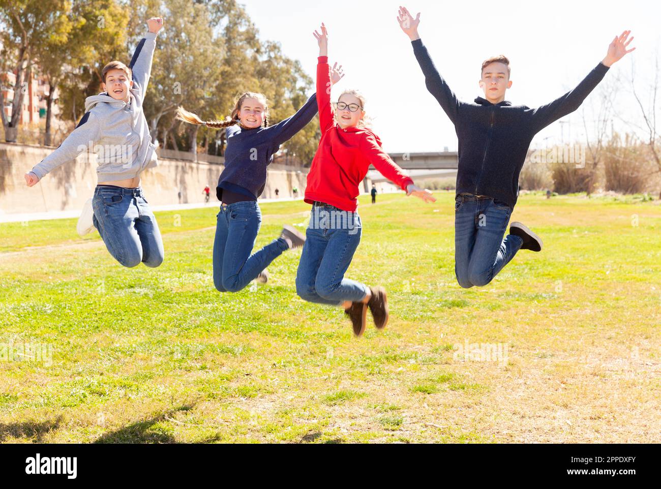 Portrait four happy friends jumping hi-res stock photography and images ...