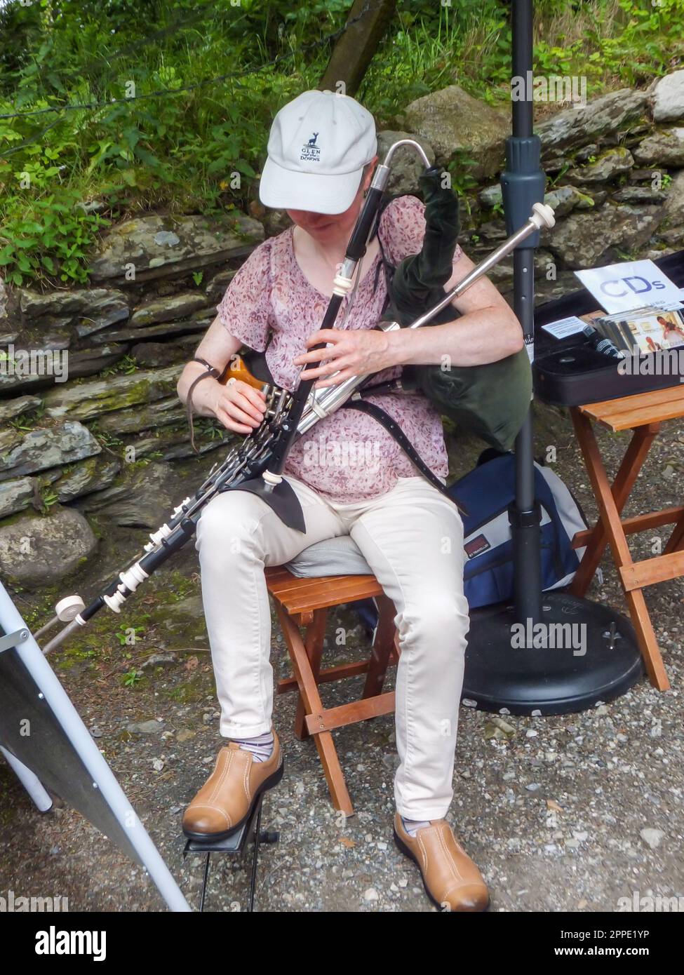 A musician plays the Uilleann bagpipes at Saint Kevin's Monastic City ...