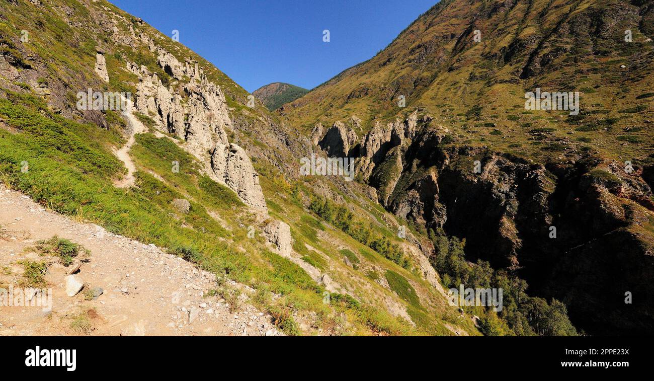 A narrow path along the steep slope of a high mountain with unusual ...