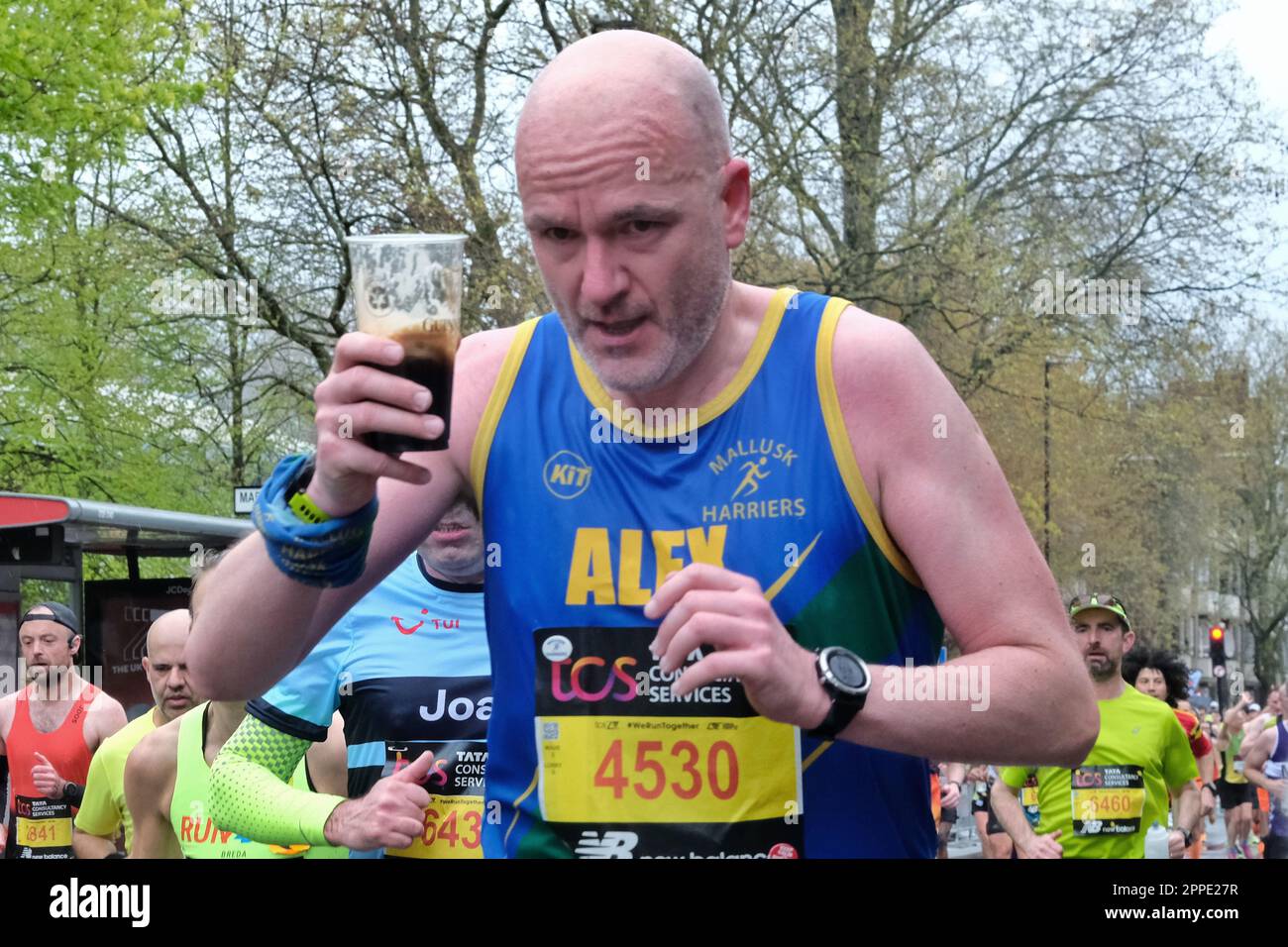 London, UK. 23rd April, 2023. Runners proceed along Jamaica Road, the ...