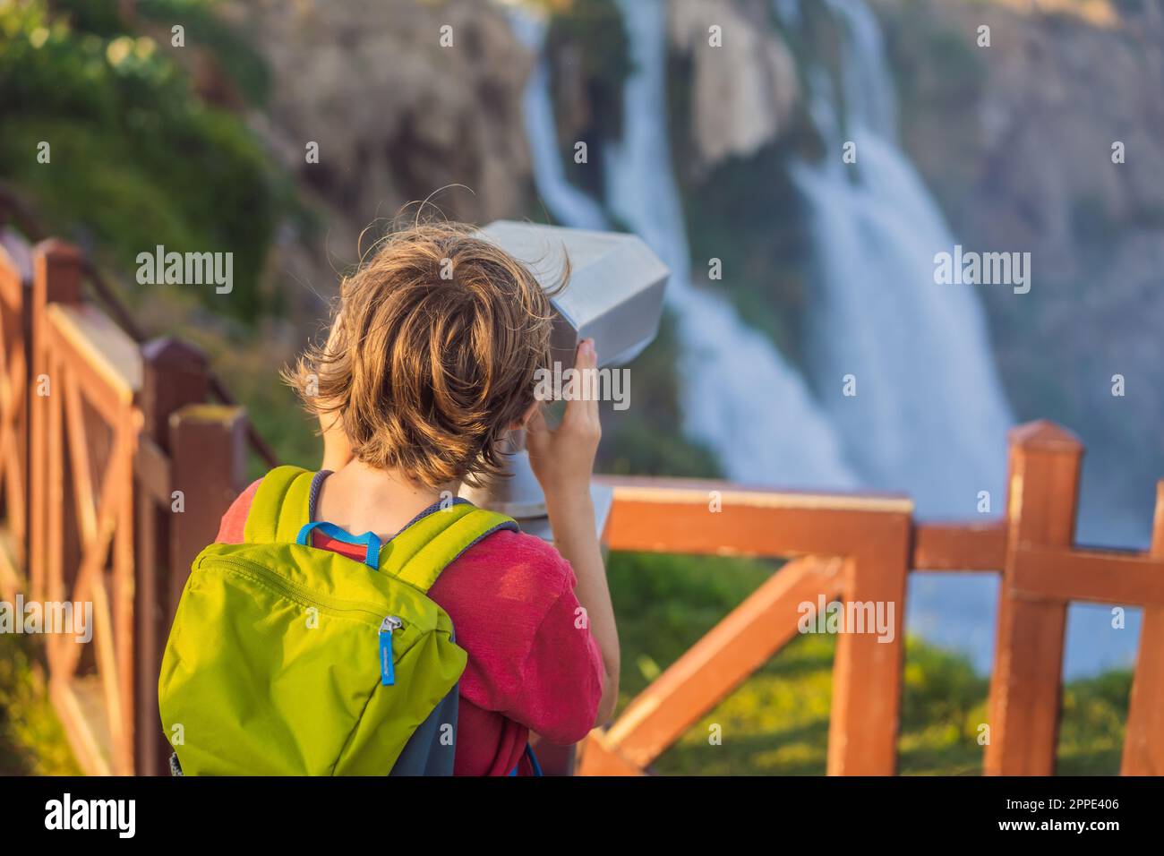 Boy tourist with a backpack on the background of Duden waterfall in ...