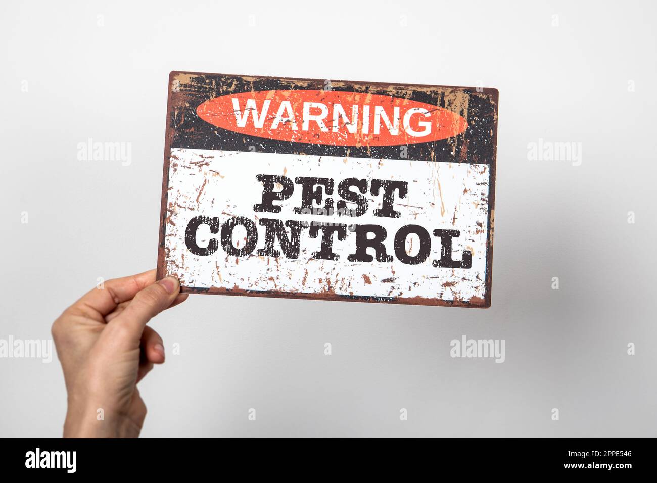 Pest Control. Warning sign with text in woman hand. white background ...