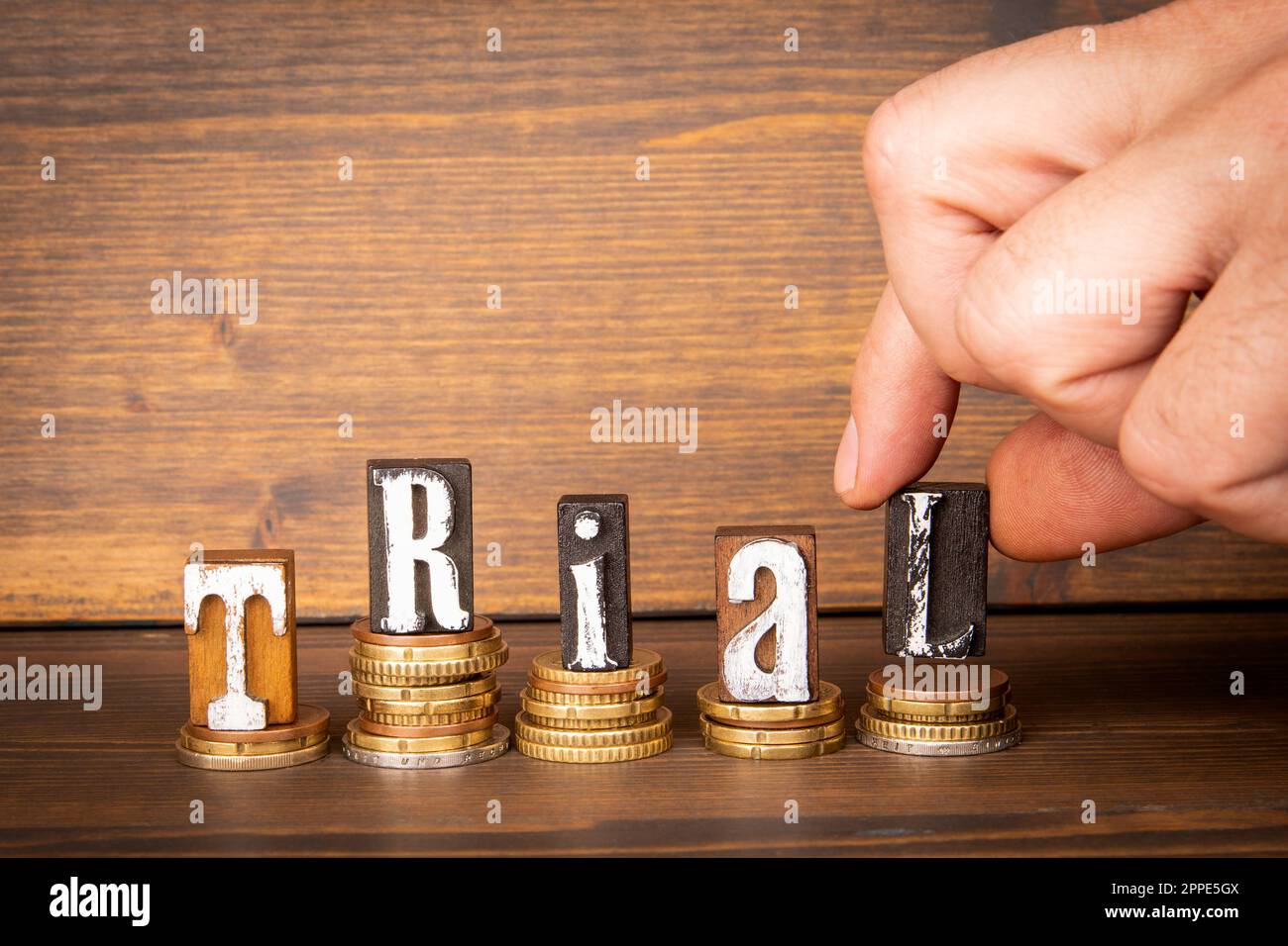 Trial. Word from alphabet blocks and change on wood texture background ...